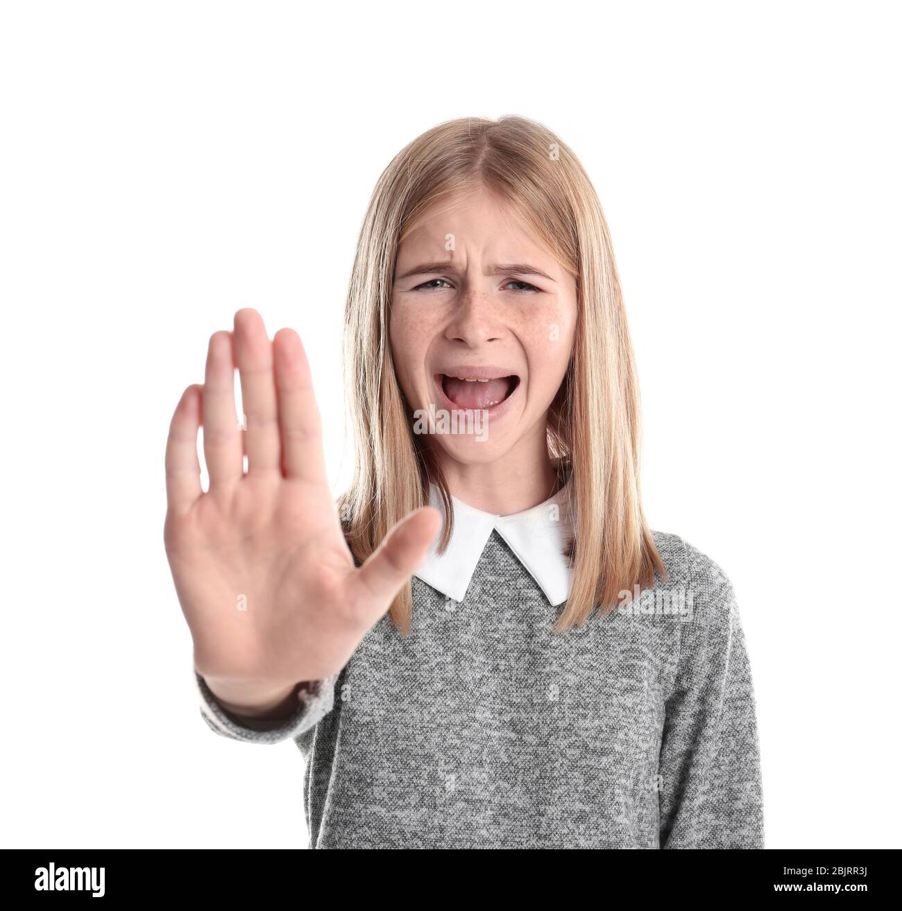 Teenage girl making stop gesture on white background Stock Photo - Alamy