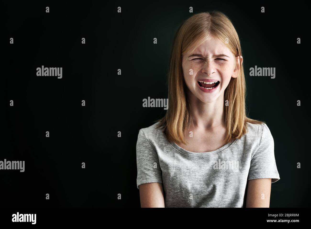 Screaming teenage girl on color background Stock Photo - Alamy