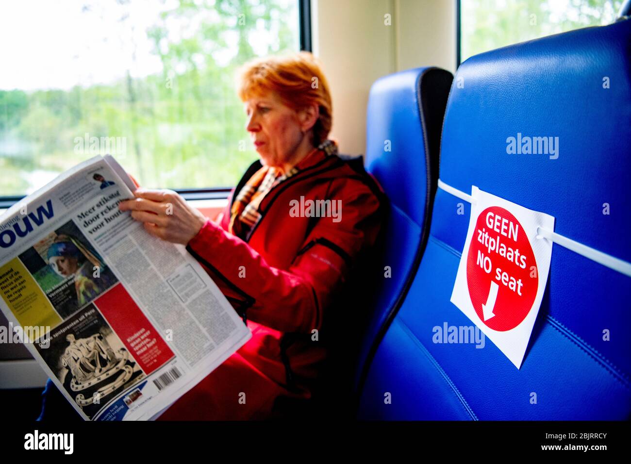 A passenger on a test train of the Dutch Railways (NS) on Groningen ...