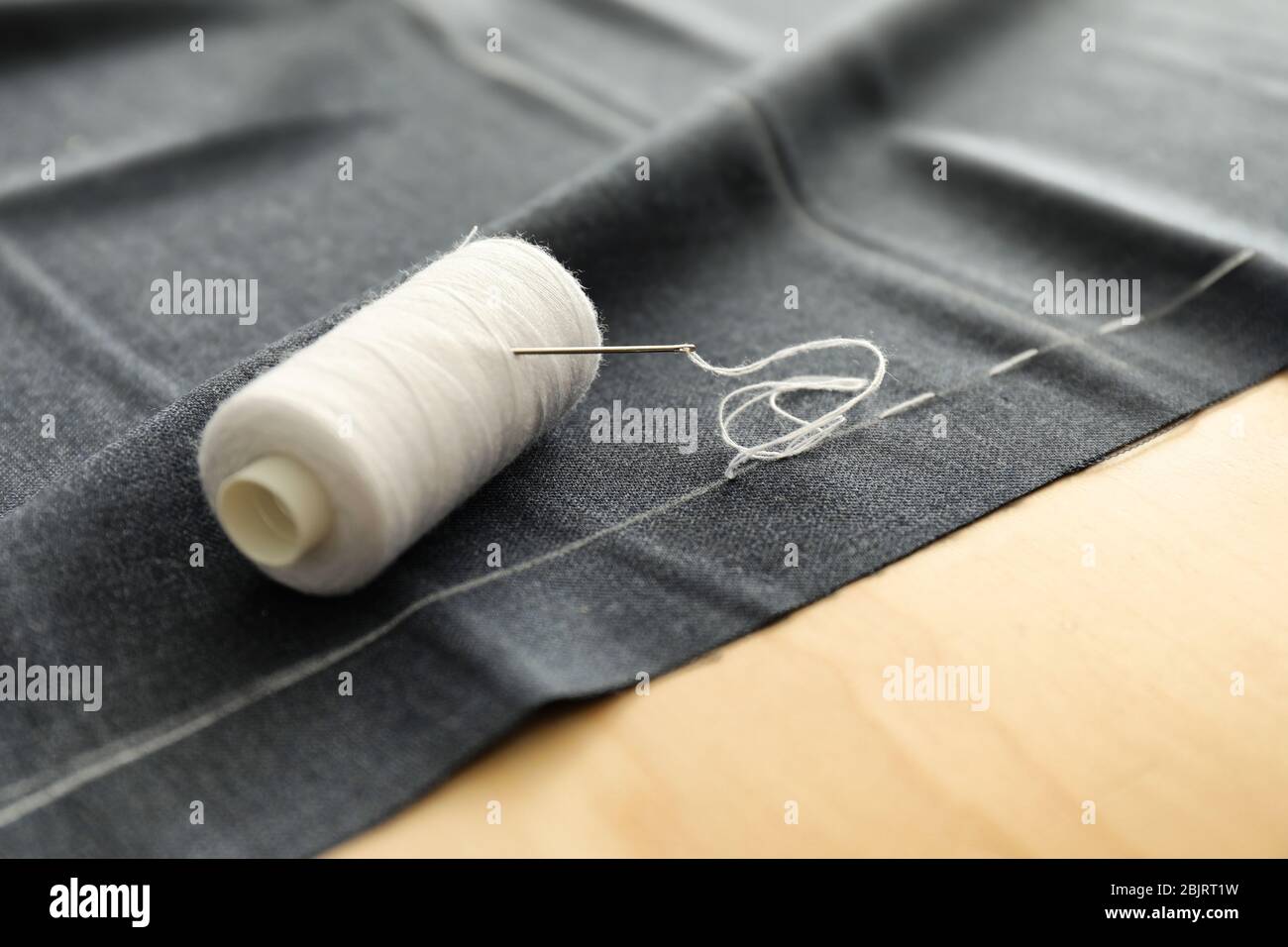 White thread on grey fabric Stock Photo - Alamy