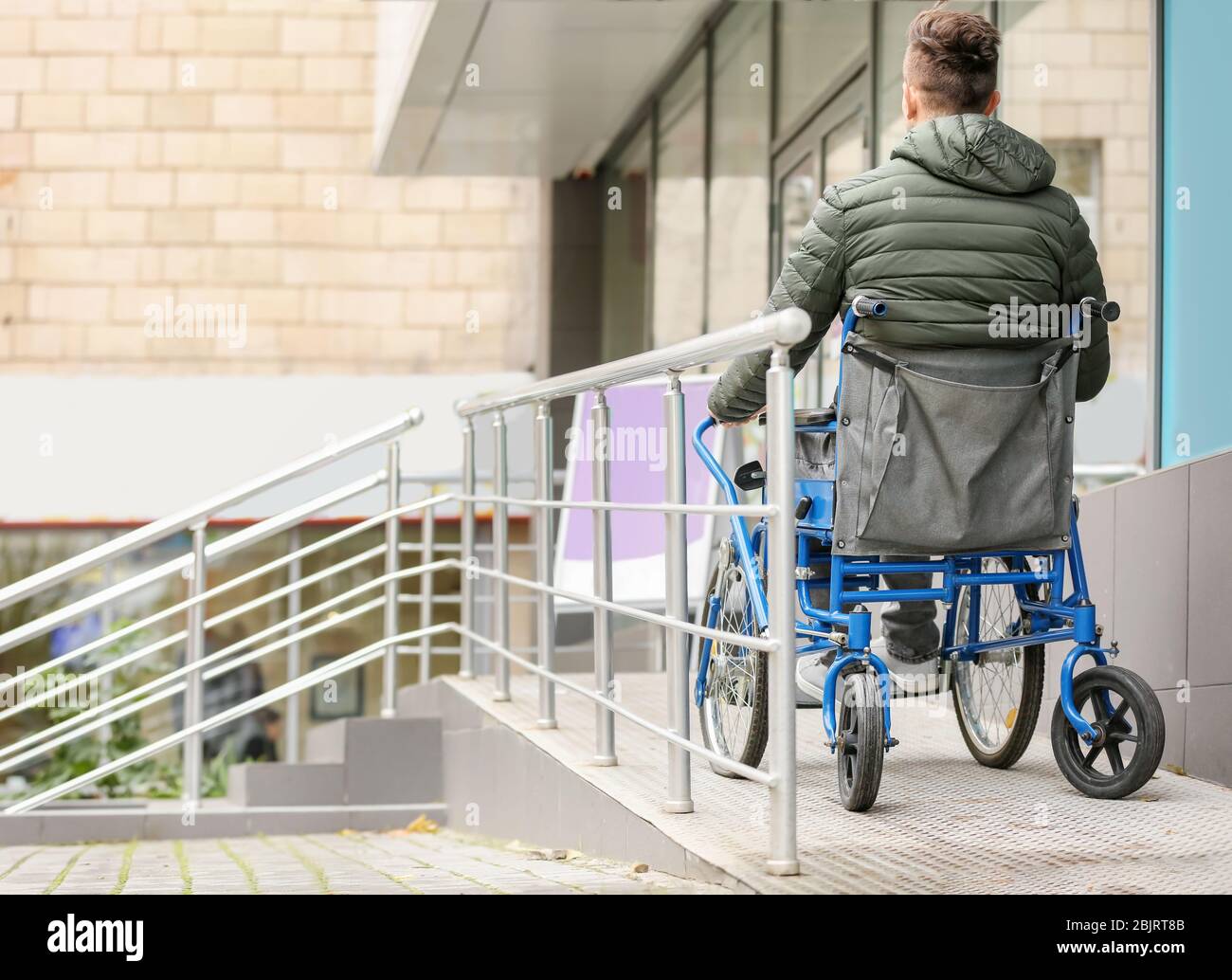 Paralyzed man in wheelchair on ramp outdoors Stock Photo - Alamy
