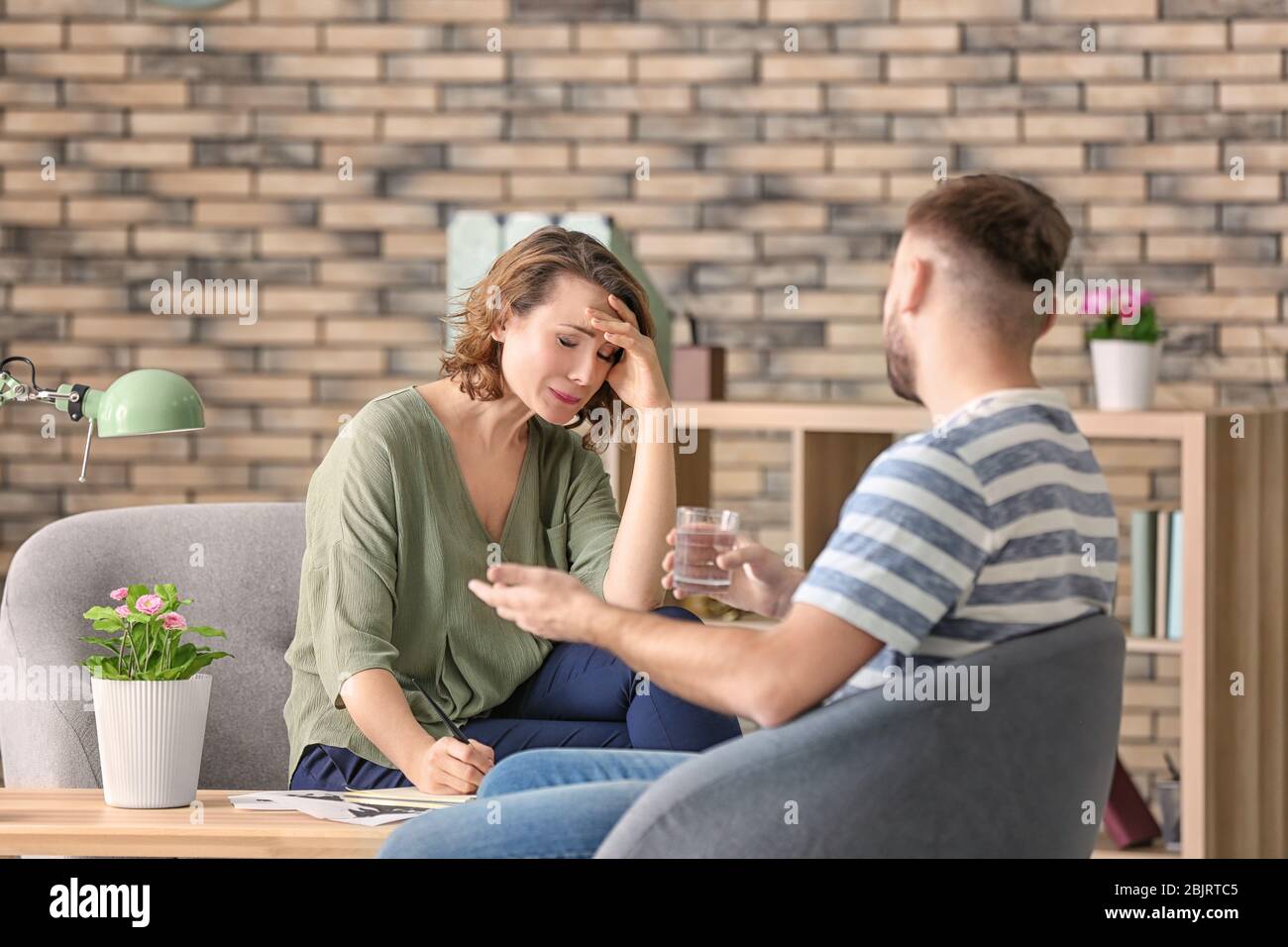 Female psychologist working with patient in office Stock Photo - Alamy