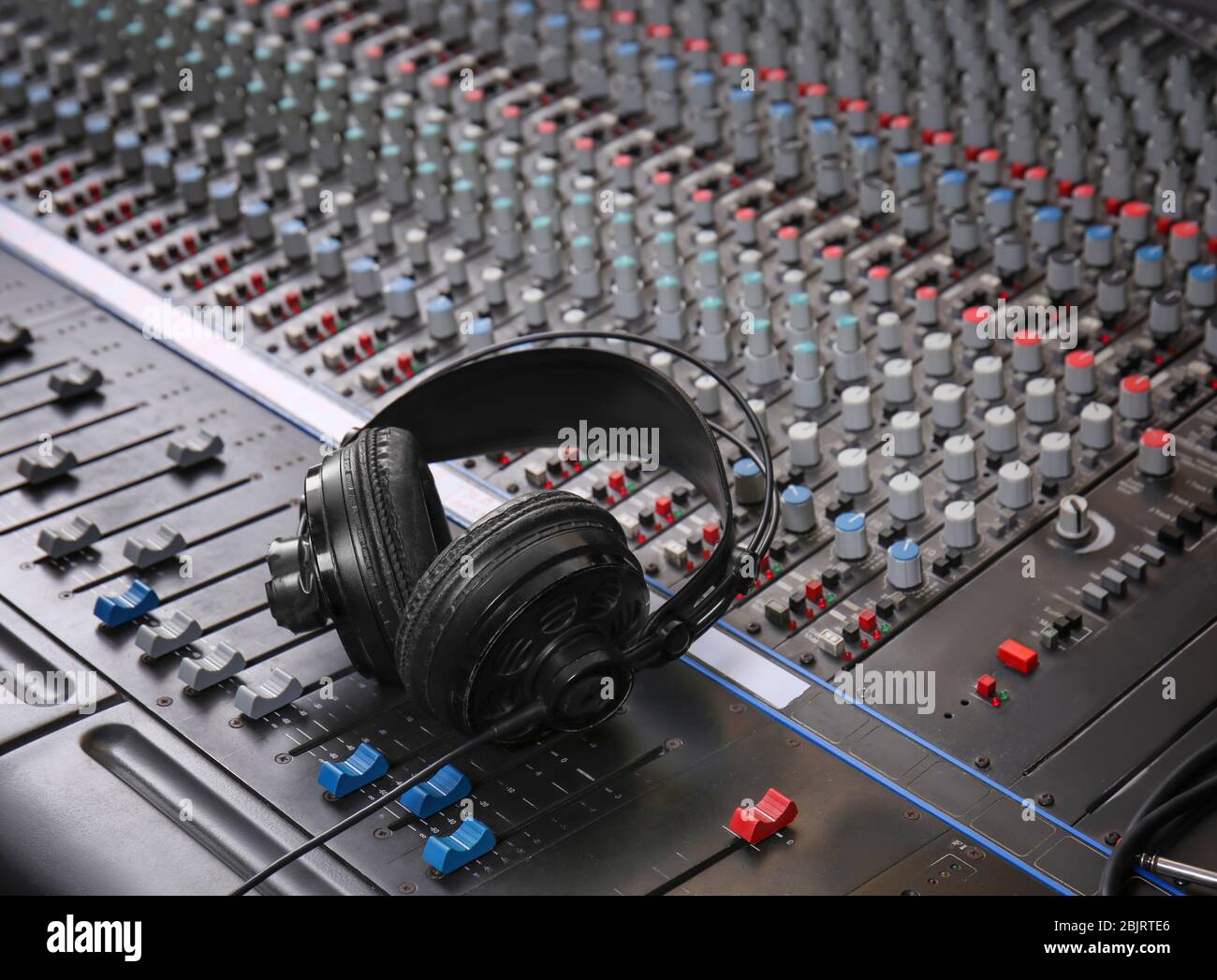 Headphones on mixer in radio station Stock Photo - Alamy
