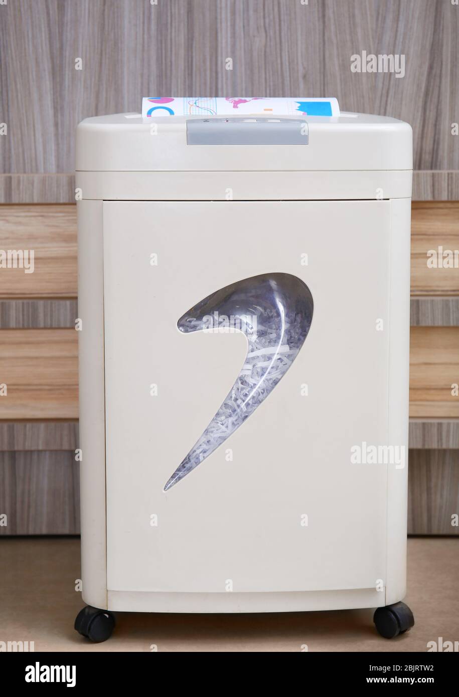 Destroying document with shredder in office Stock Photo - Alamy