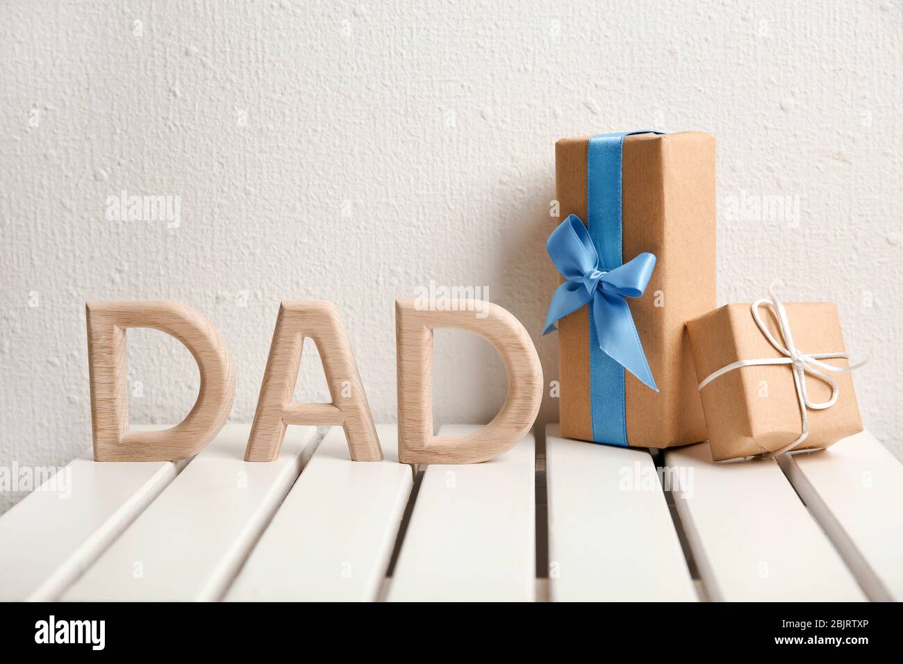 Word "Dad" made of wooden letters and gift boxes for Father's day on ...