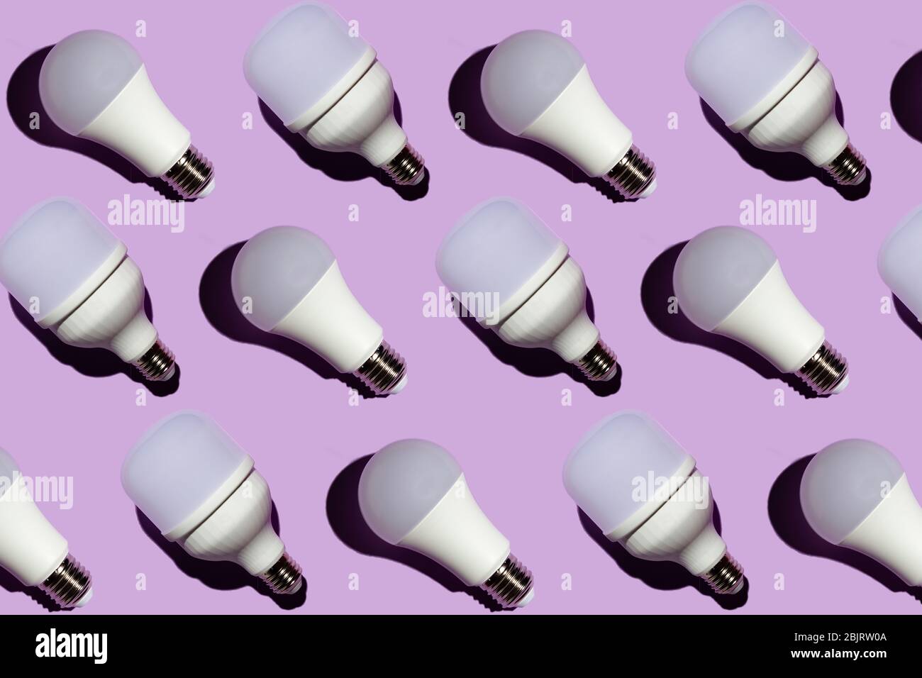 Pattern of led light bulbs with hard shadows on a purple background ...