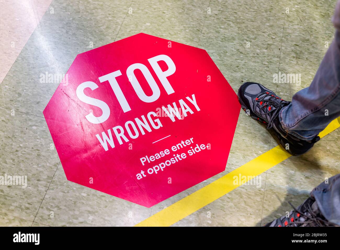 Red warning stop direction sign for entering wrong way in store aisle ...