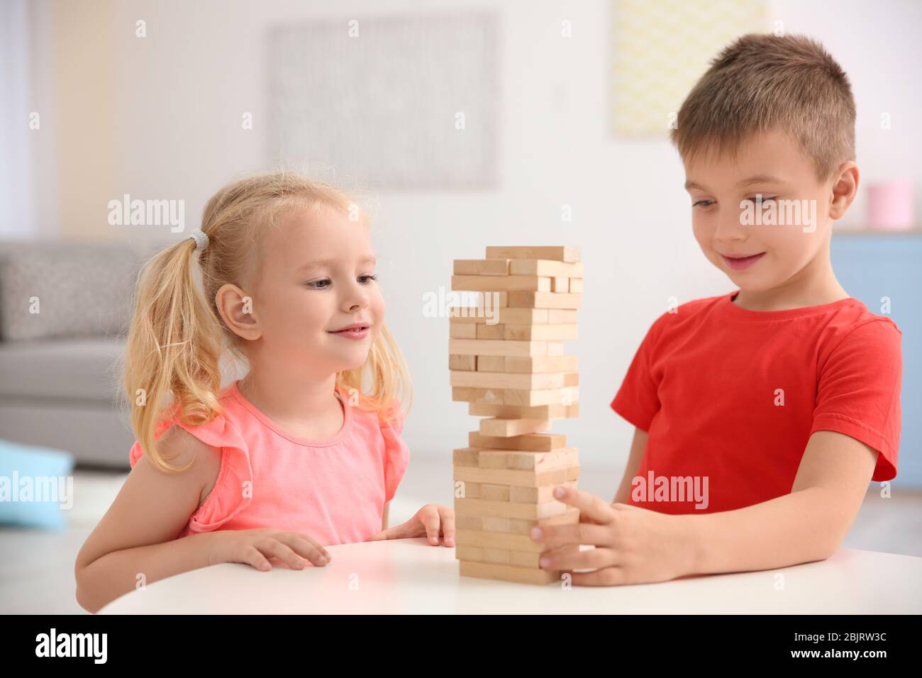 Cute little children playing with building blocks at home Stock Photo ...