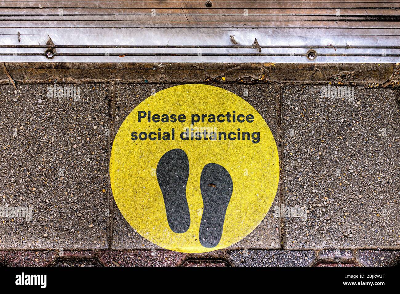 Above view for yellow warning sign to maintain social distance ...