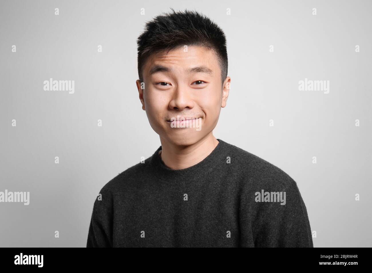 Portrait of young Asian man on light background Stock Photo - Alamy