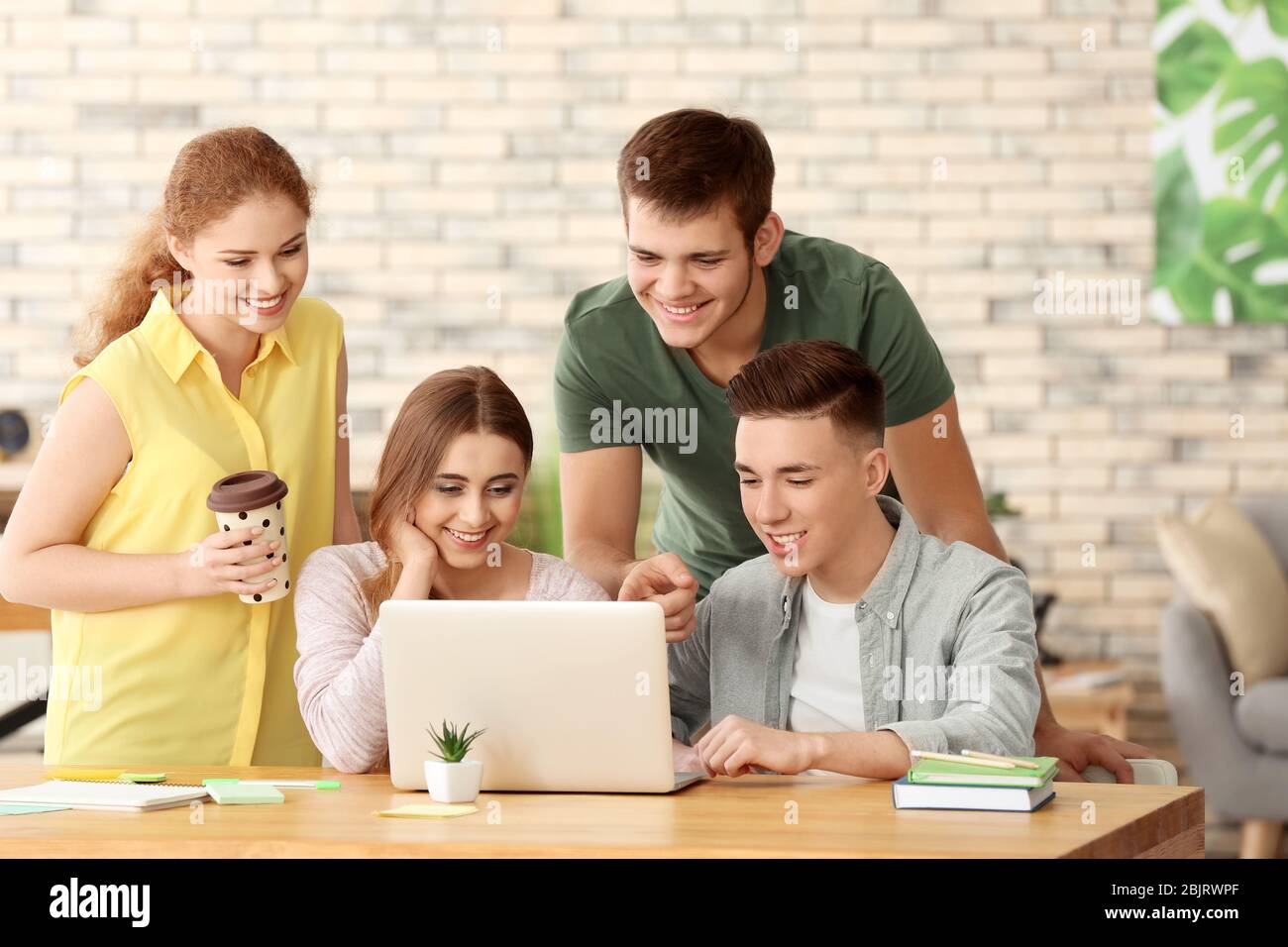 Group of teenagers with laptop studying indoors Stock Photo - Alamy