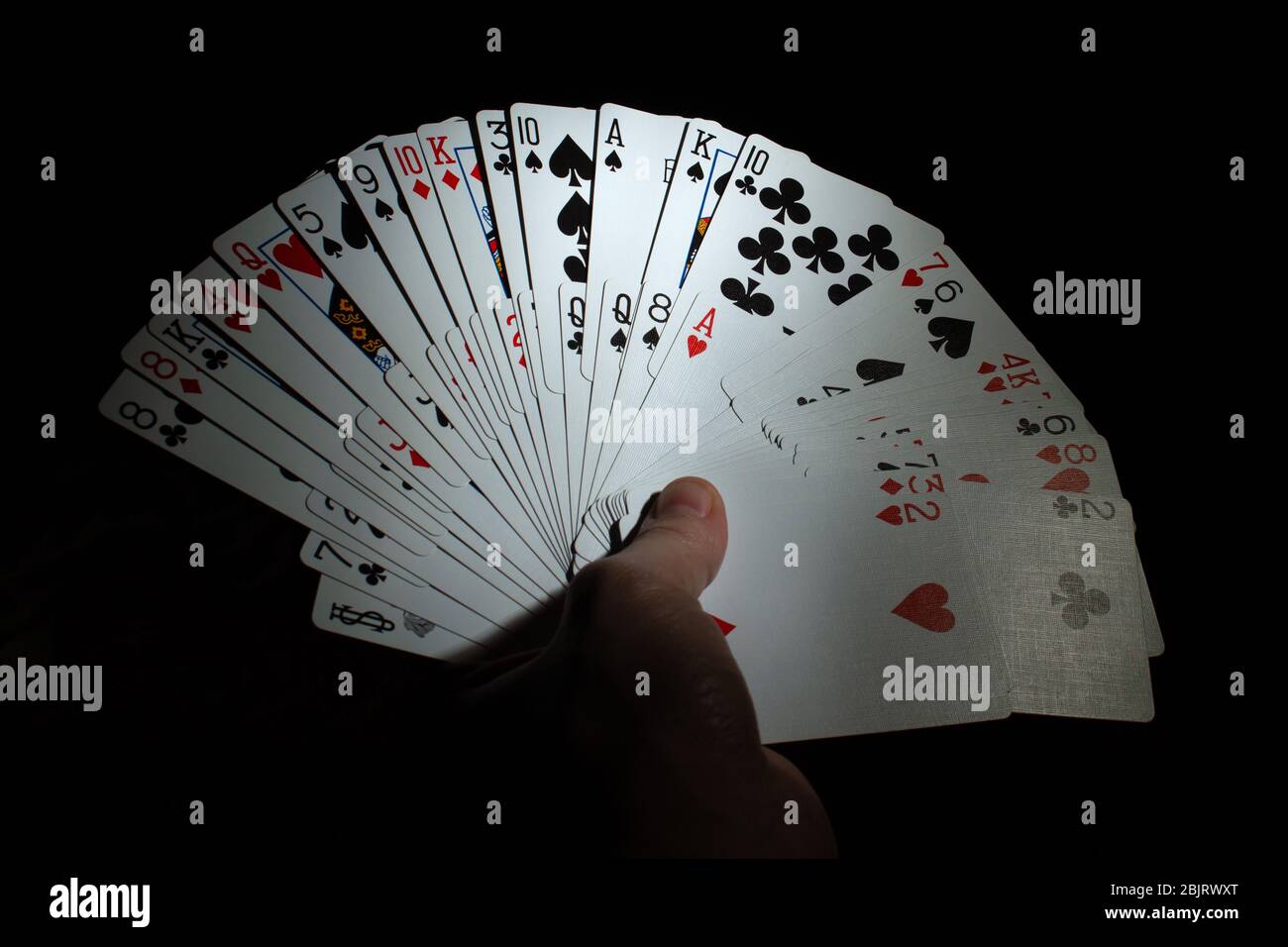 hand hold double fan from poker cards deck on black background copy ...