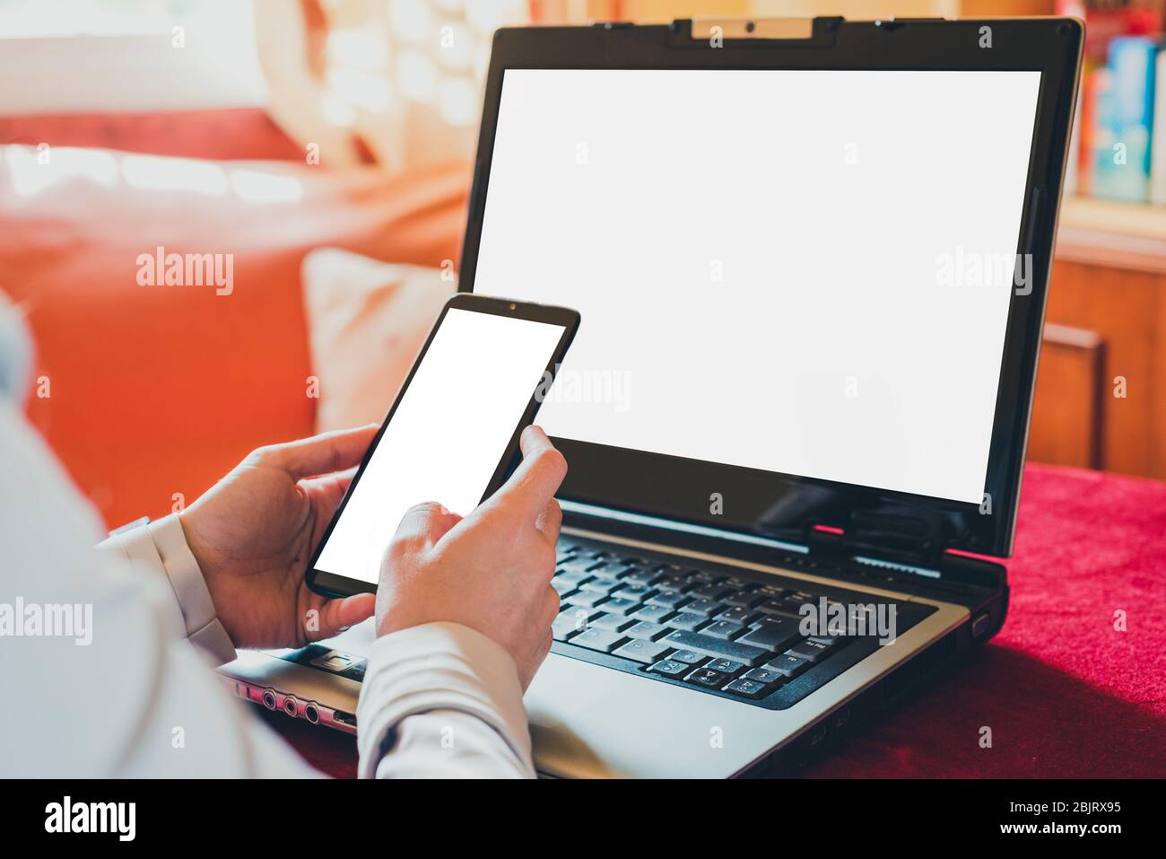 women's hands using smartphone and laptop Stock Photo - Alamy