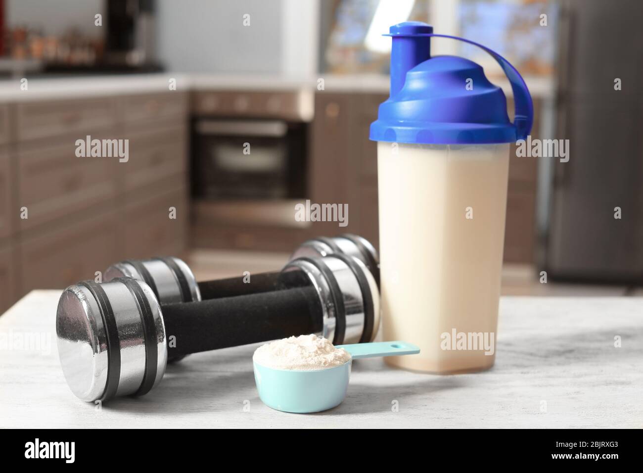 Composition with protein powder, shake and dumbbells on table Stock ...