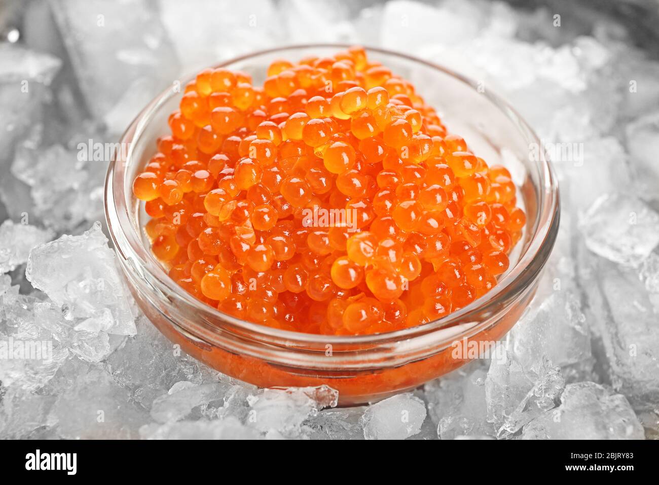 Bowl with delicious red caviar on ice, closeup Stock Photo - Alamy