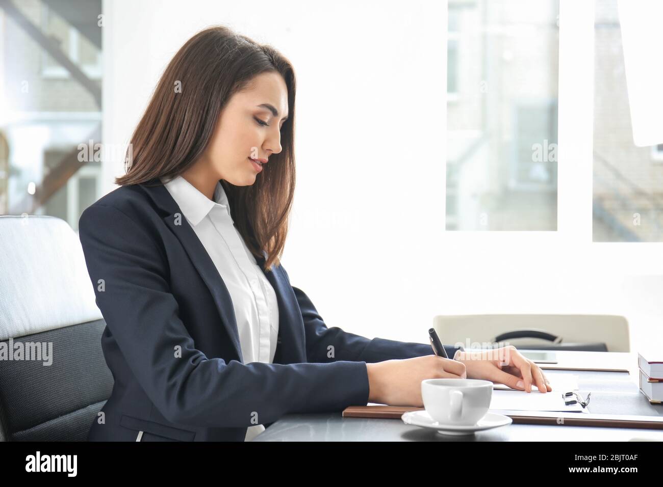 Attractive young lawyer in office Stock Photo - Alamy