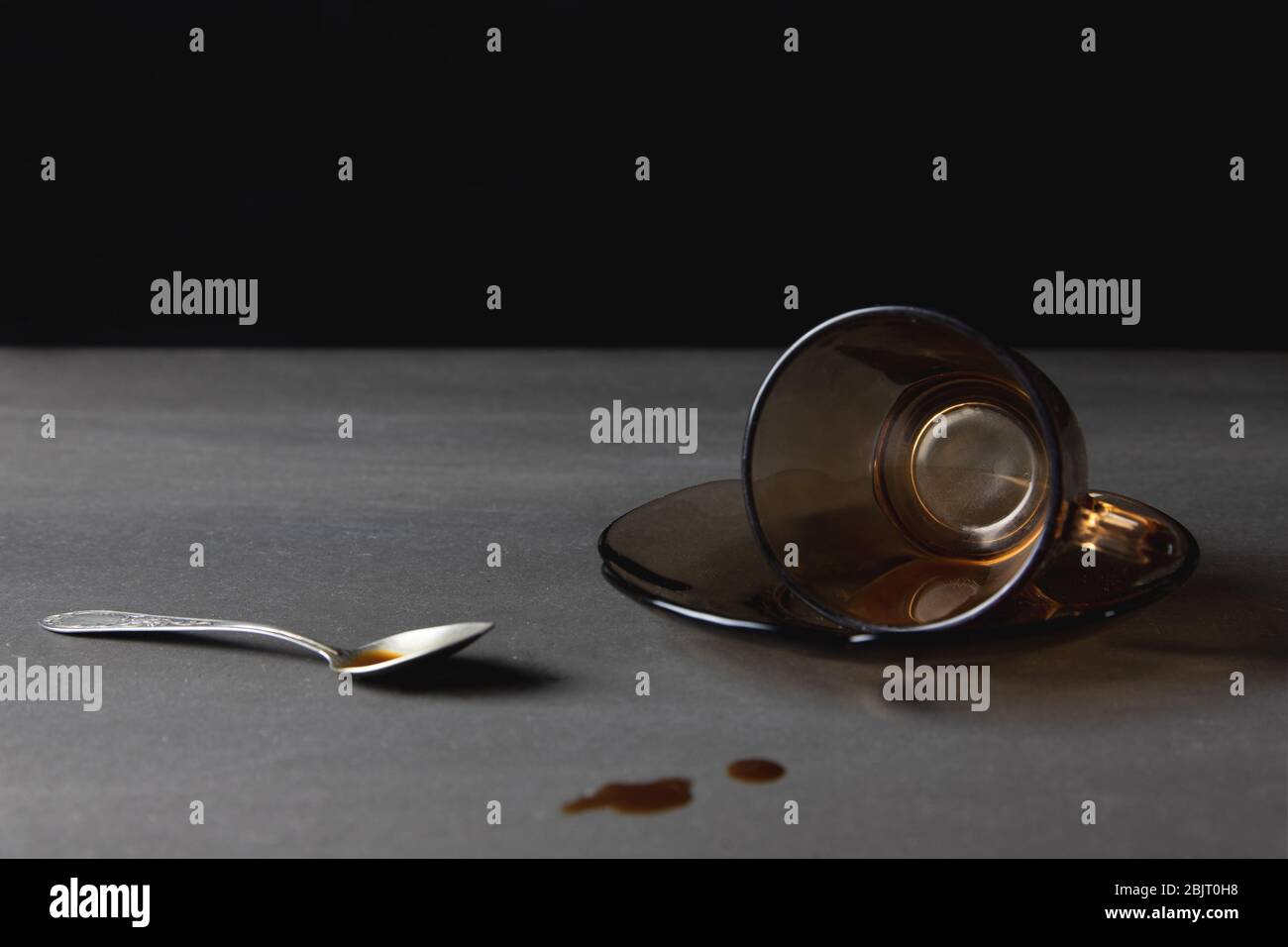 Spilled coffee, morning espresso, spilled brown glass of coffee, metal ...