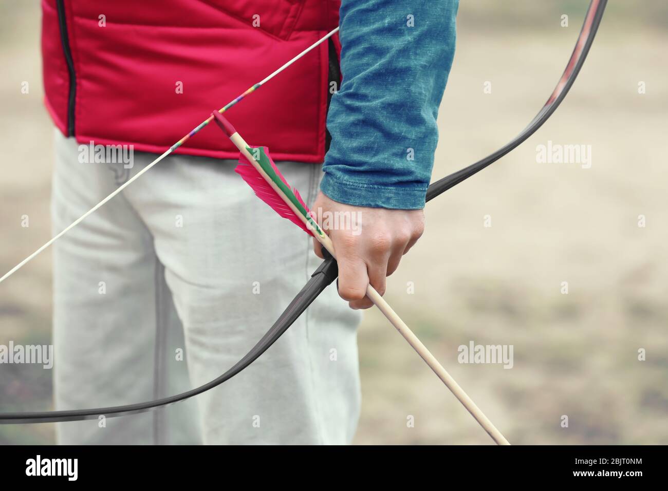 Young woman holding bow arrow hi-res stock photography and images - Alamy