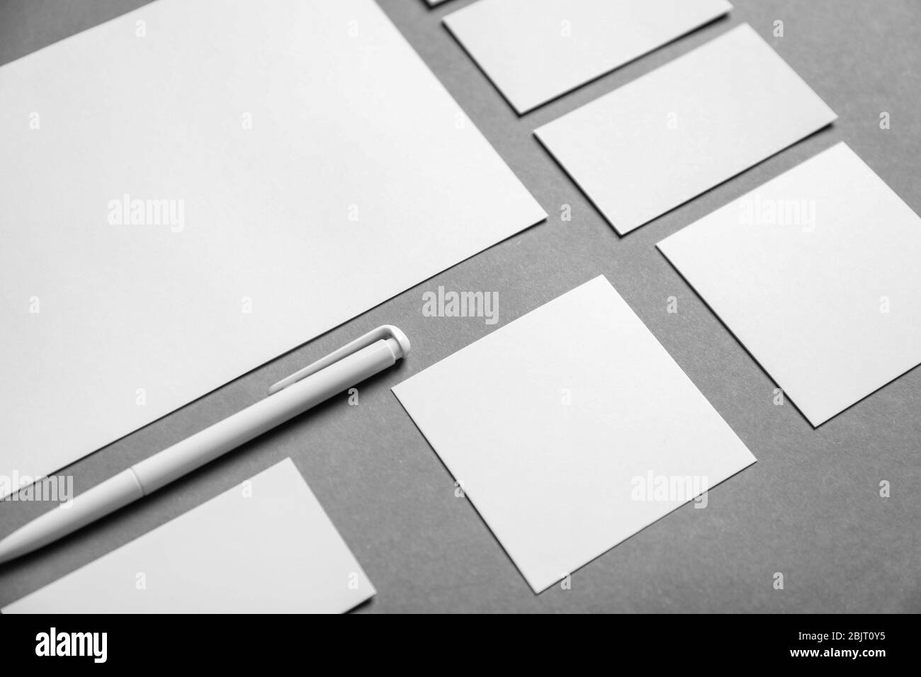 Blank items as mockups for branding on grey background Stock Photo - Alamy