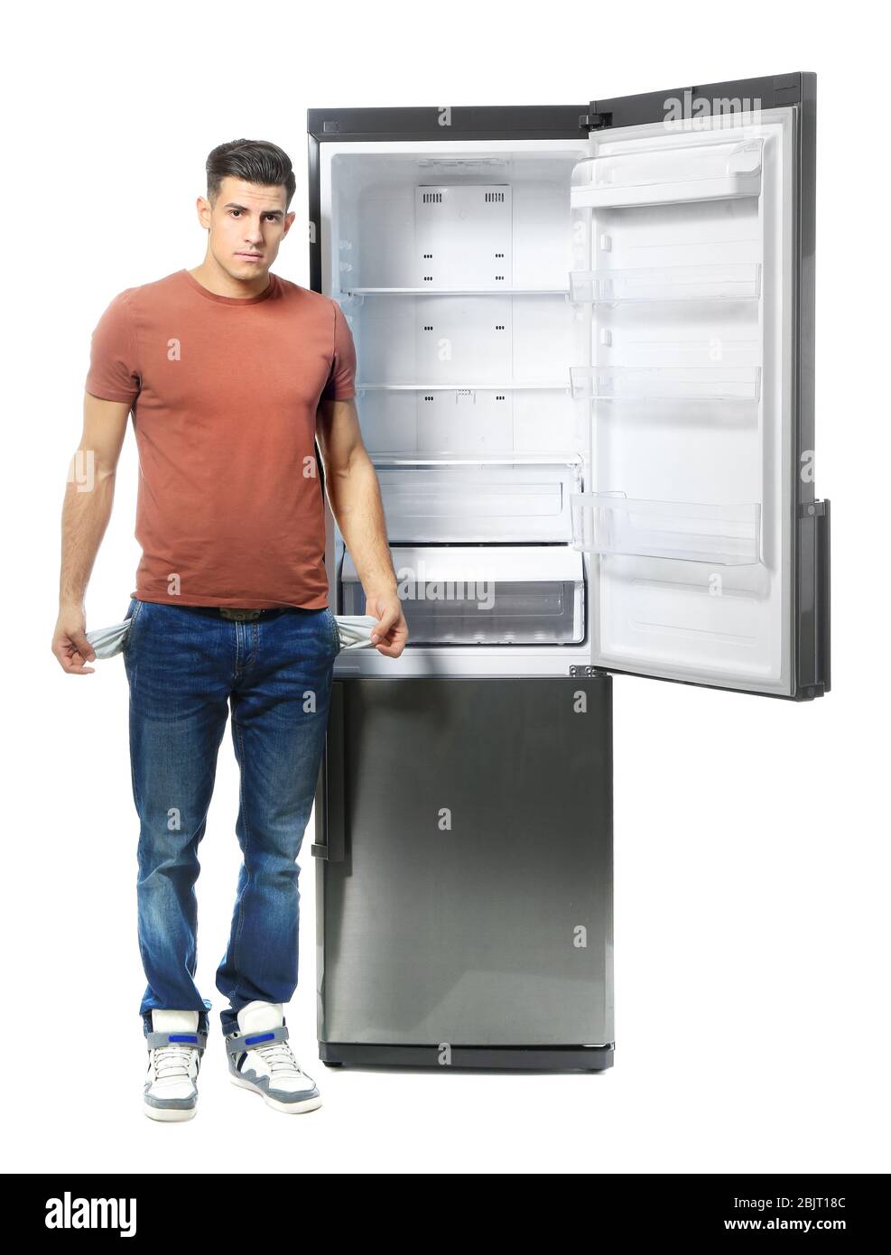 Hungry man standing near empty refrigerator, on white background Stock ...
