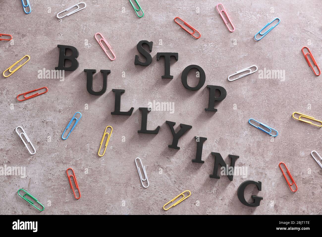 Text "Stop bullying" on grey background Stock Photo - Alamy