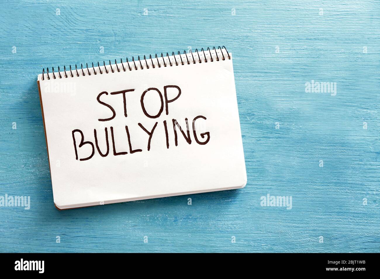 Notebook with text "Stop bullying" on color background, top view Stock ...