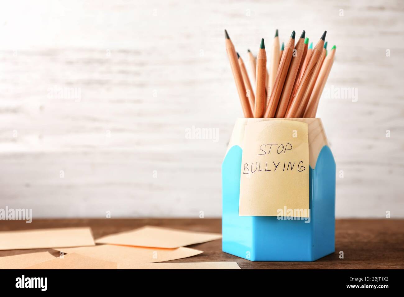 Sticky note with text "Stop bullying" on pencil holder Stock Photo - Alamy
