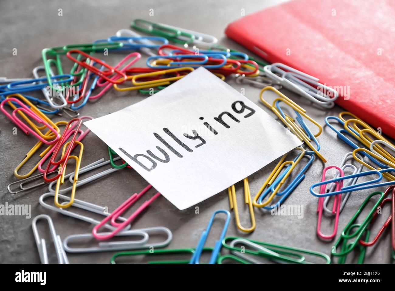 Note with word "Bullying" and paper clips on grey background Stock ...