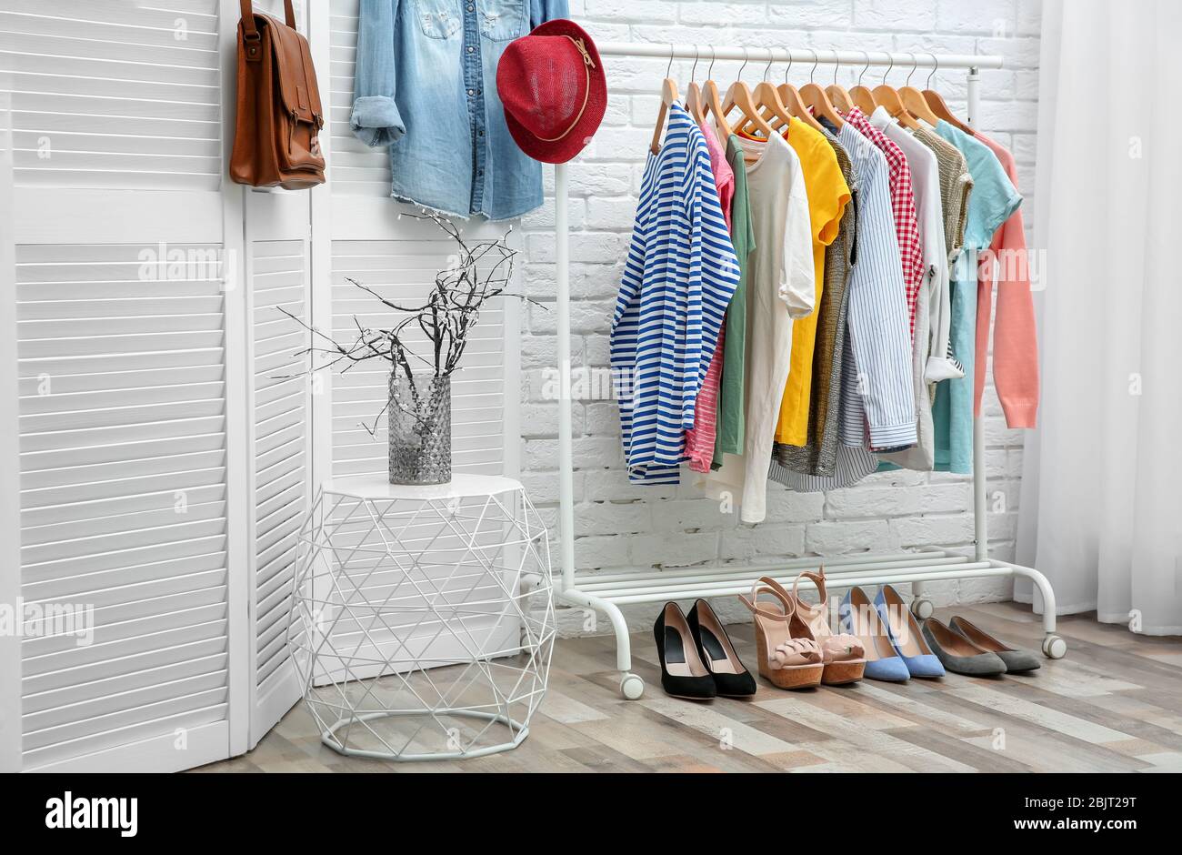 Neat dressing room interior with clothes rack Stock Photo - Alamy