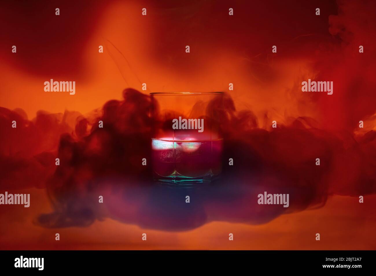 Cocktail in a glass rox glass with ice smoke burns on Lush Lava ...