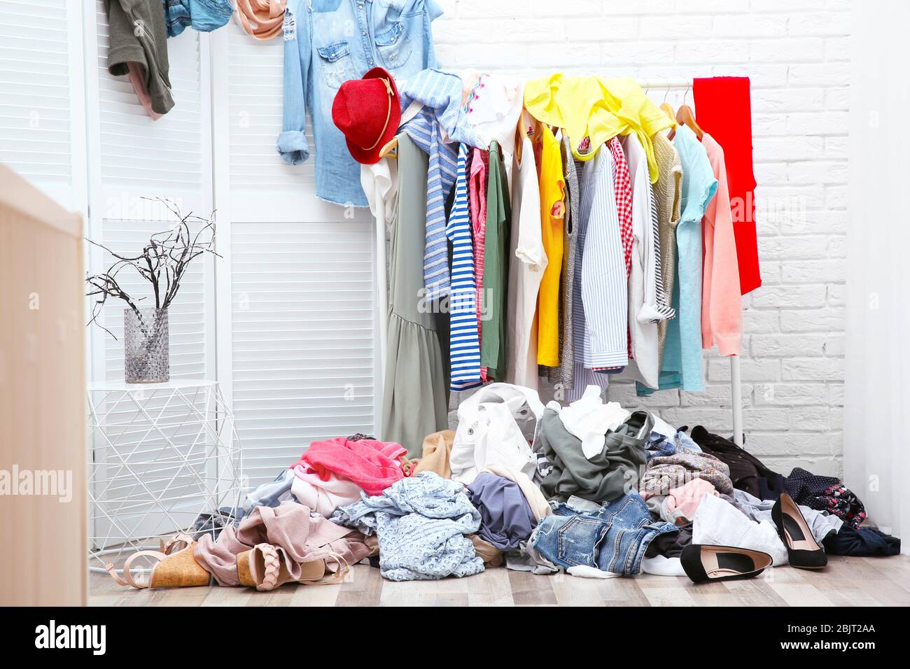 Messy dressing room interior with clothes rack Stock Photo - Alamy