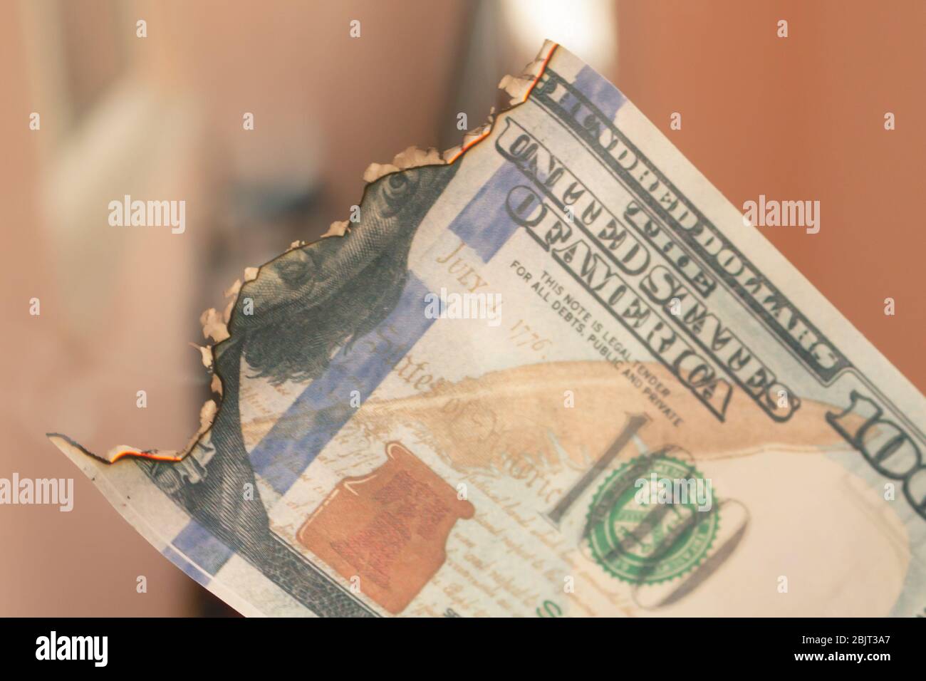 hundred dollar bill burns on a light background Stock Photo - Alamy