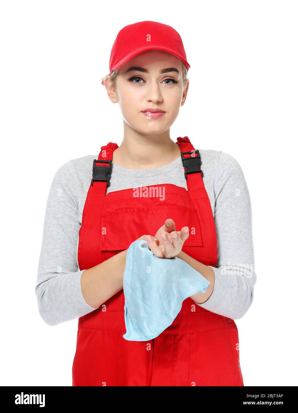 Female auto mechanic wiping hands with rag on white background Stock ...