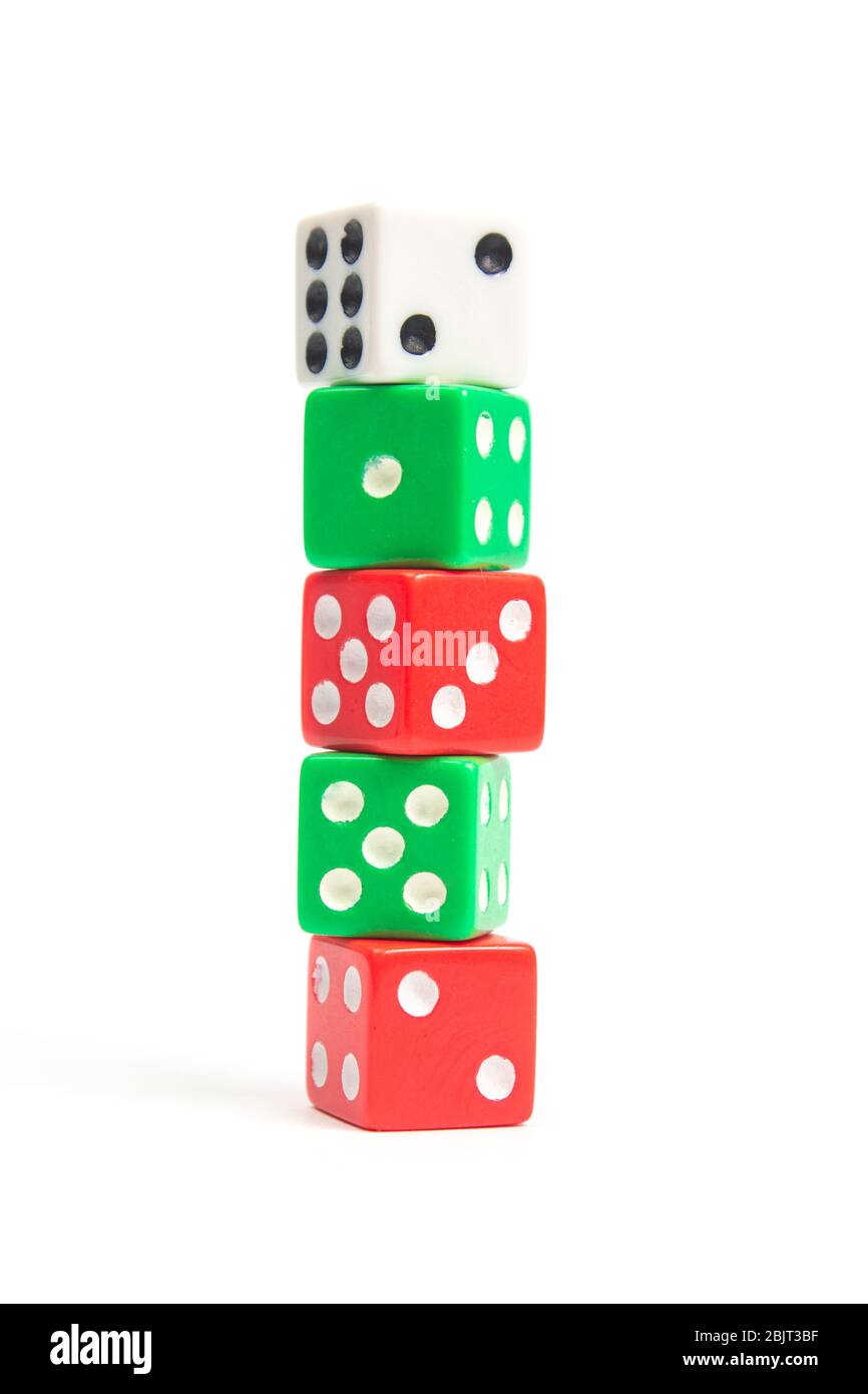 game dice of white red and green stand on each other on a white ...