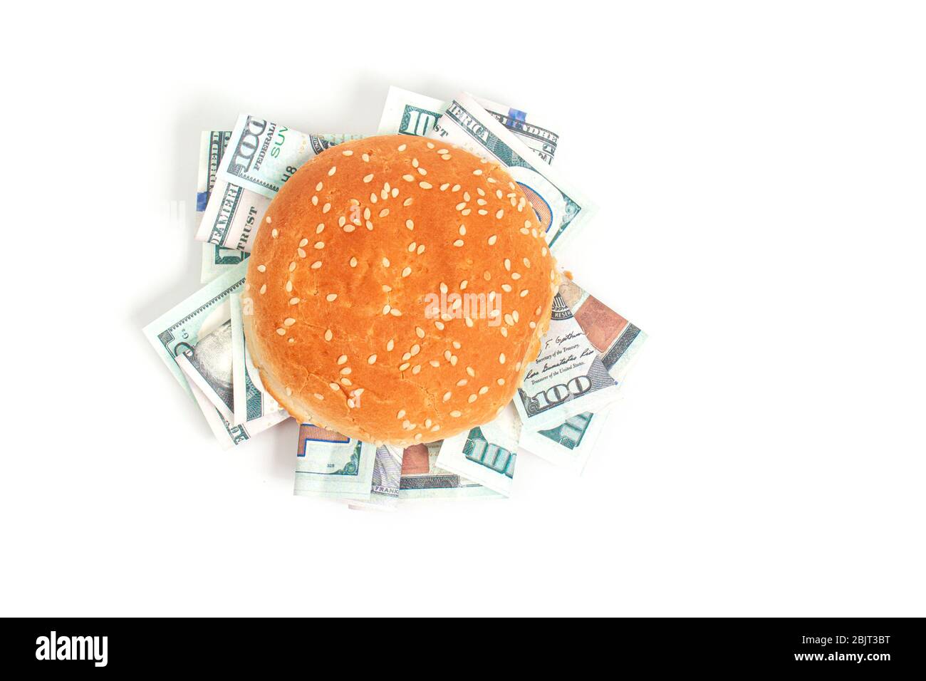 burger with hundred dollar bills instead of toppings on a white ...