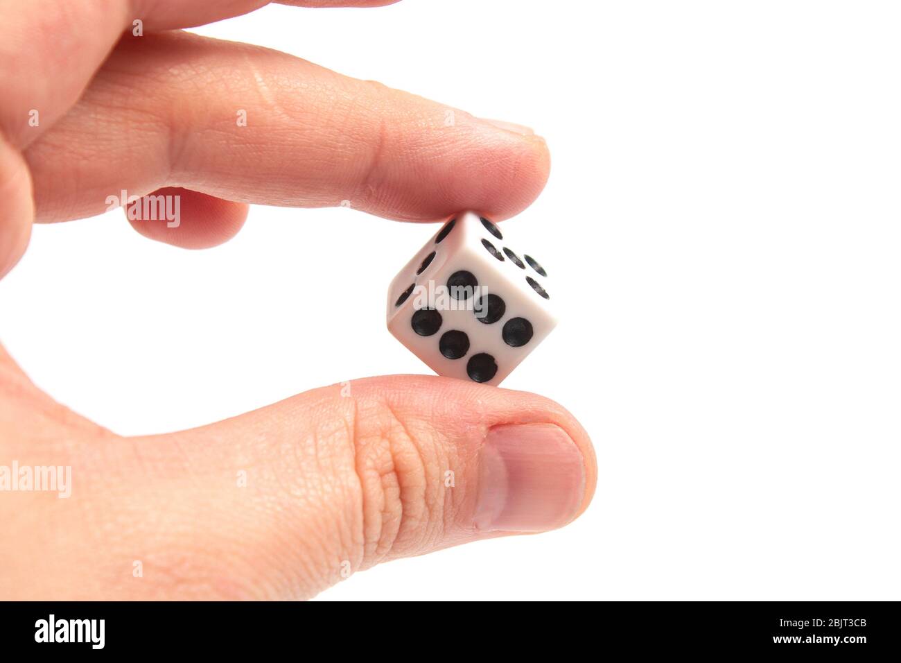 game dice of white color in a hand on a white background isolate, side ...