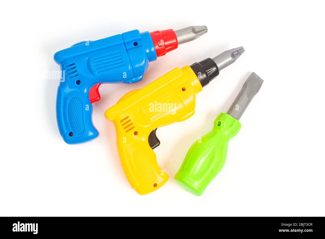 blue and yellow toy screwdriver and green screwdriver on a white ...