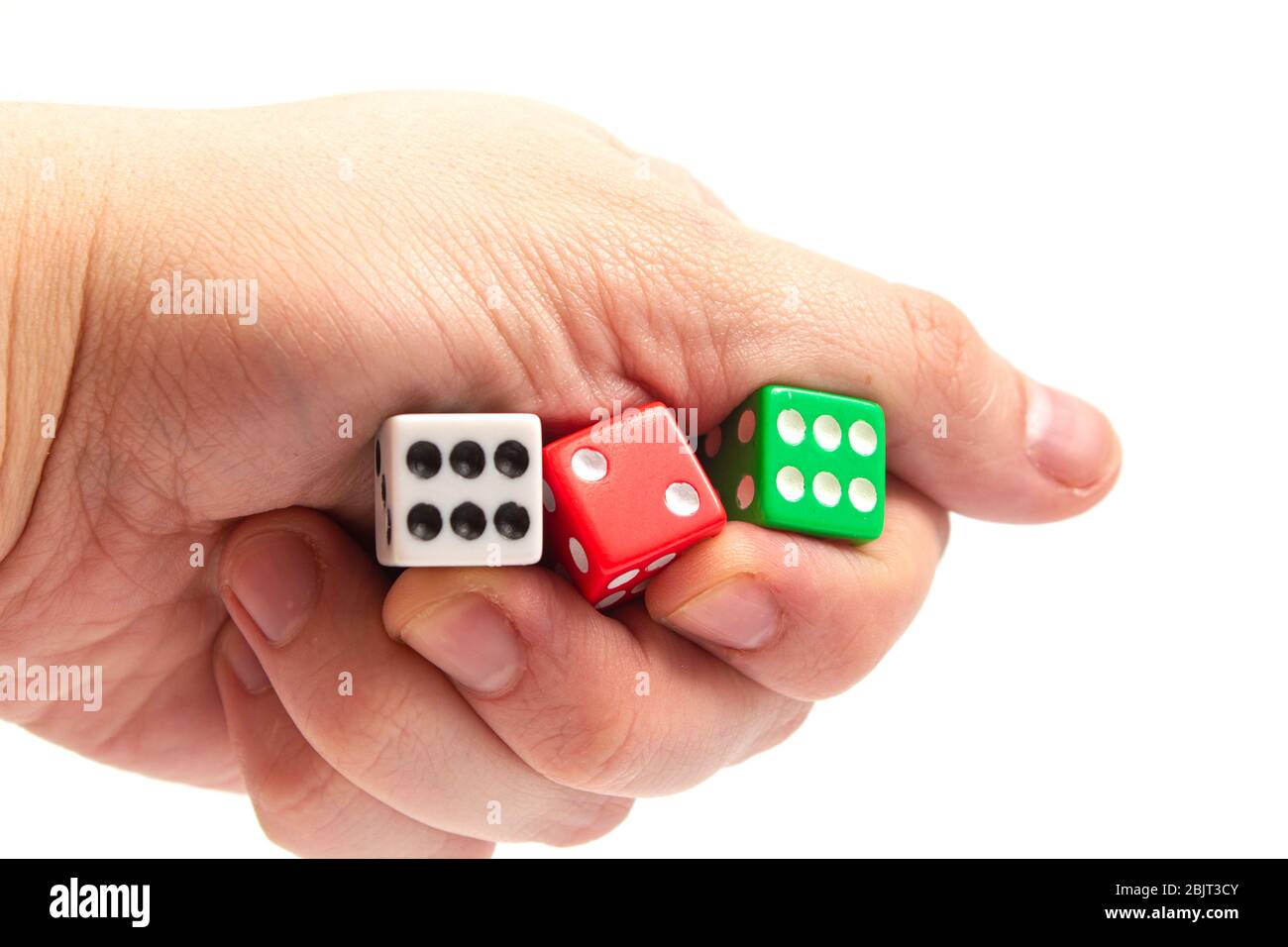 game dice of white red and green color in a hand on a white background ...