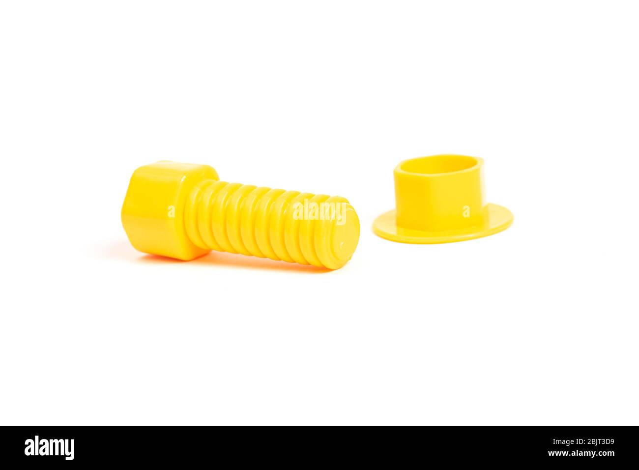 yellow toy bolt and nut on a white background isolate, side view Stock ...