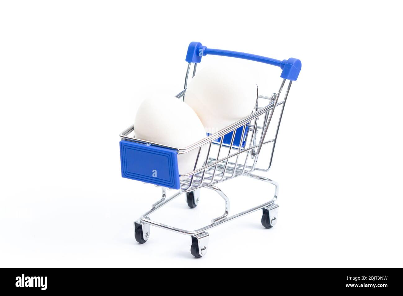 shopping cart with white chicken eggs on a white background. isolate ...