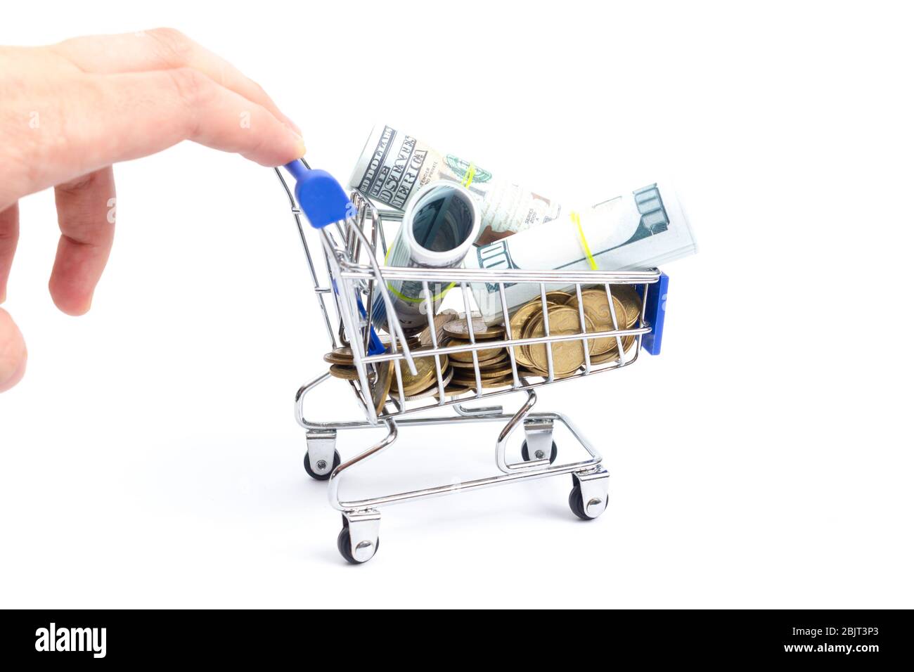 shopping cart with coins and rolls of dollars pushed by hand on a white ...