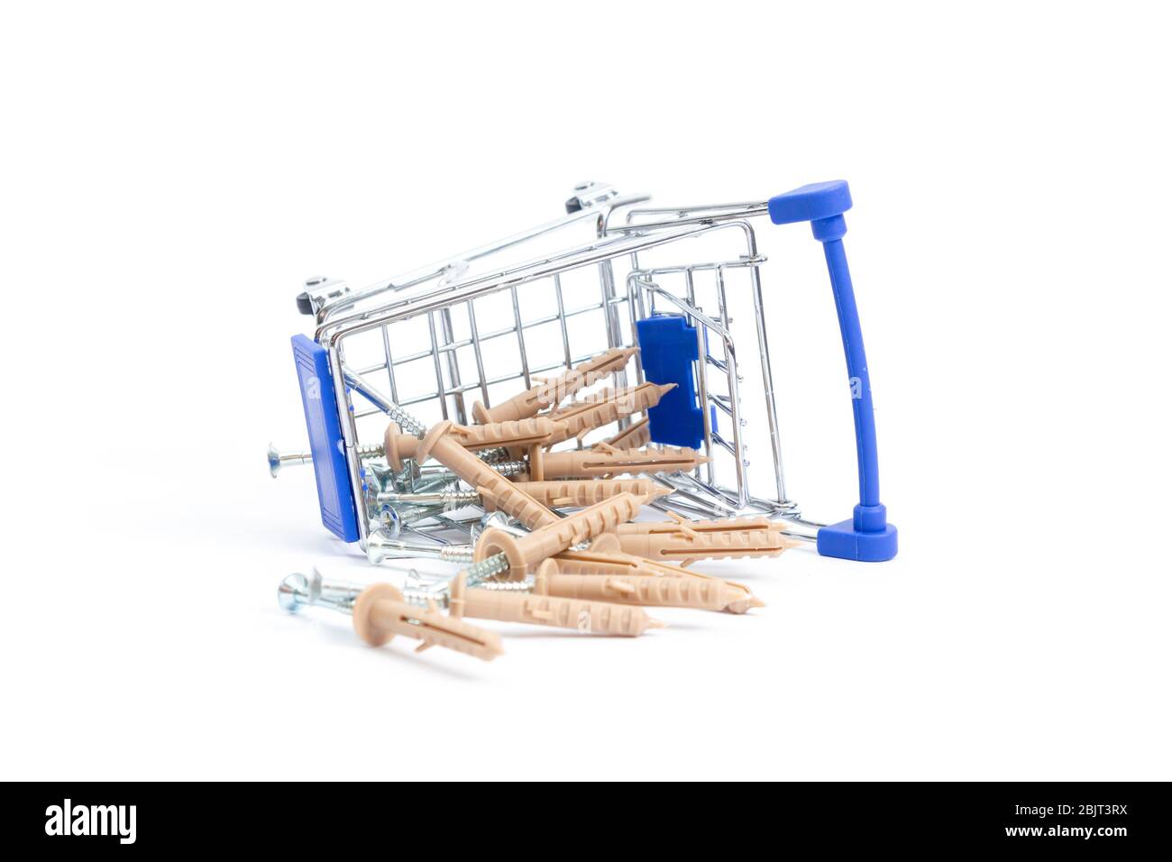 fallen shopping cart with screws for the wall on a white background ...