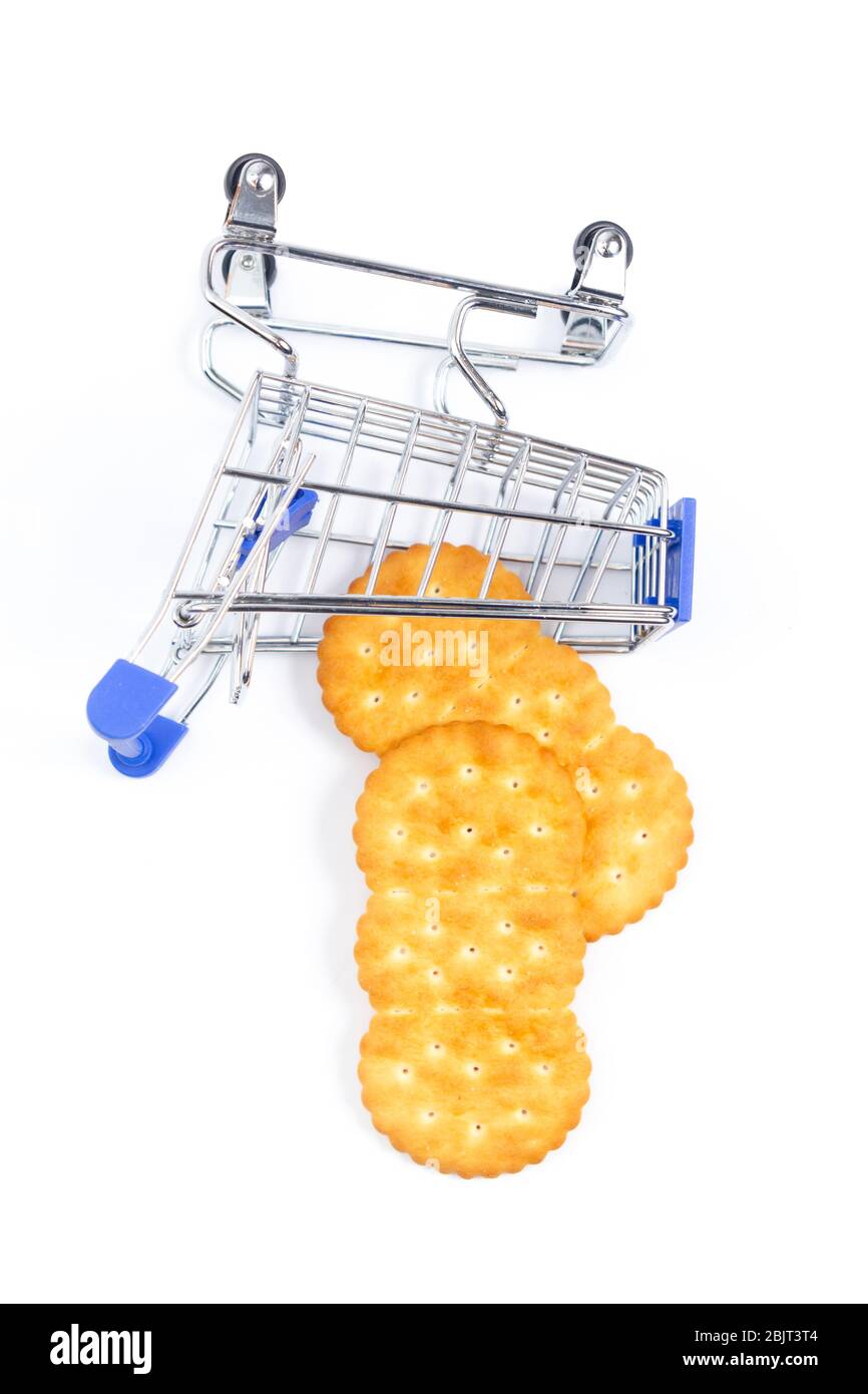 fallen shopping cart with crackers on a white background. isolate, top ...