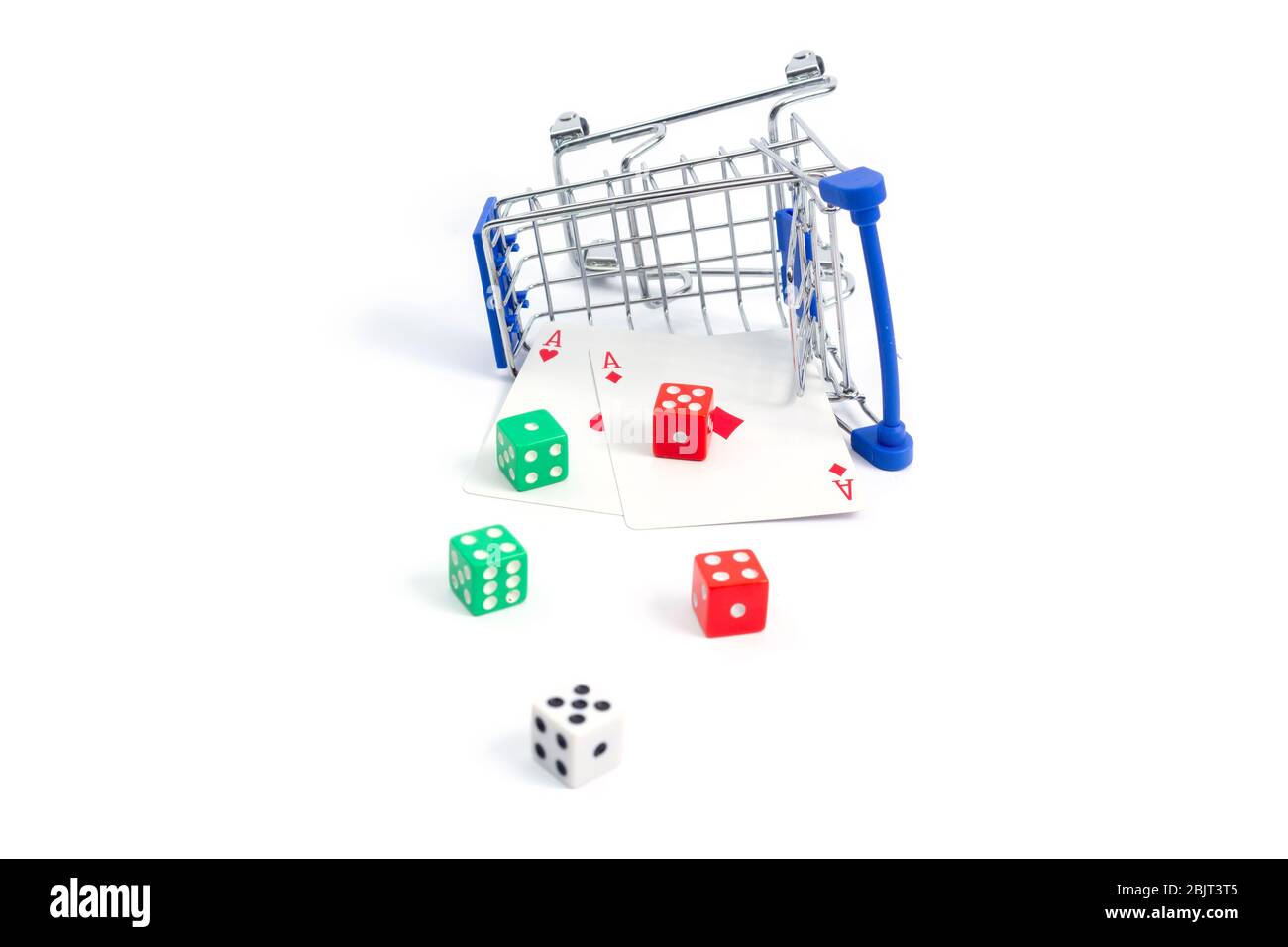 fallen shopping cart with playing cards two red aces diamond, heart and ...