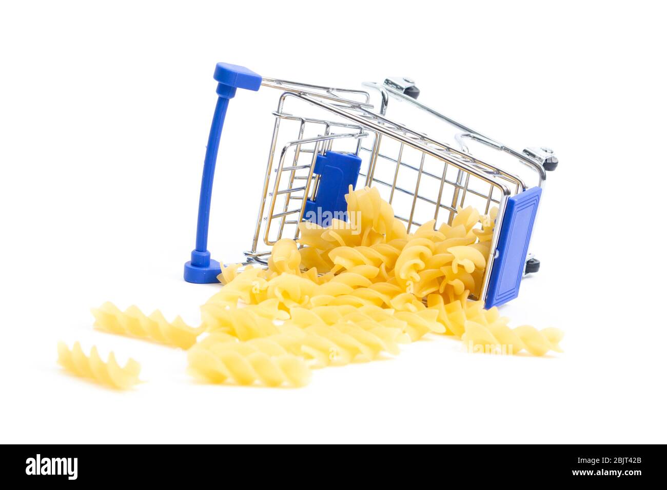 fallen shopping cart with swirling pasta on a white background. isolate ...