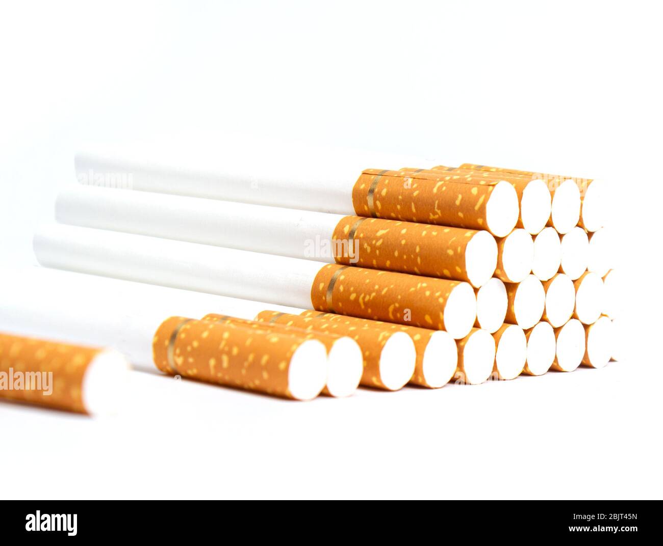 orange colored cigarettes with a gold ribbon on a white background ...