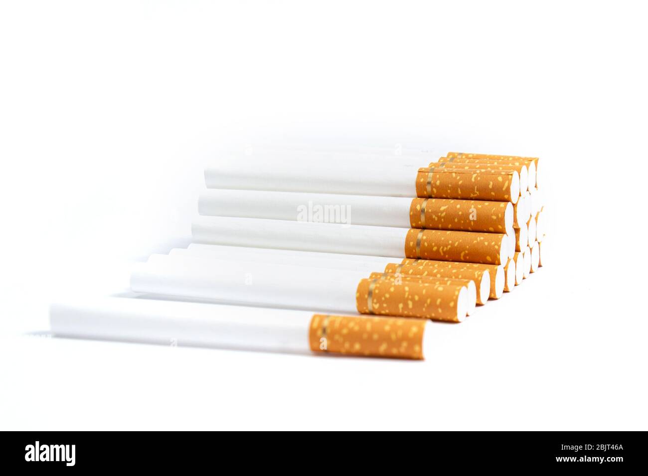 orange colored cigarettes with a gold ribbon on a white background ...