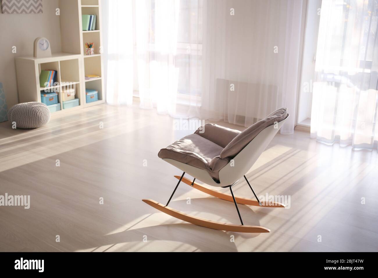 Elegant living room interior with comfortable rocking chair Stock Photo ...