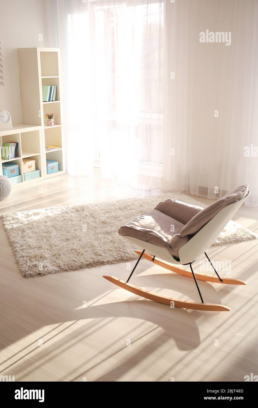 Elegant living room interior with comfortable rocking chair Stock Photo ...