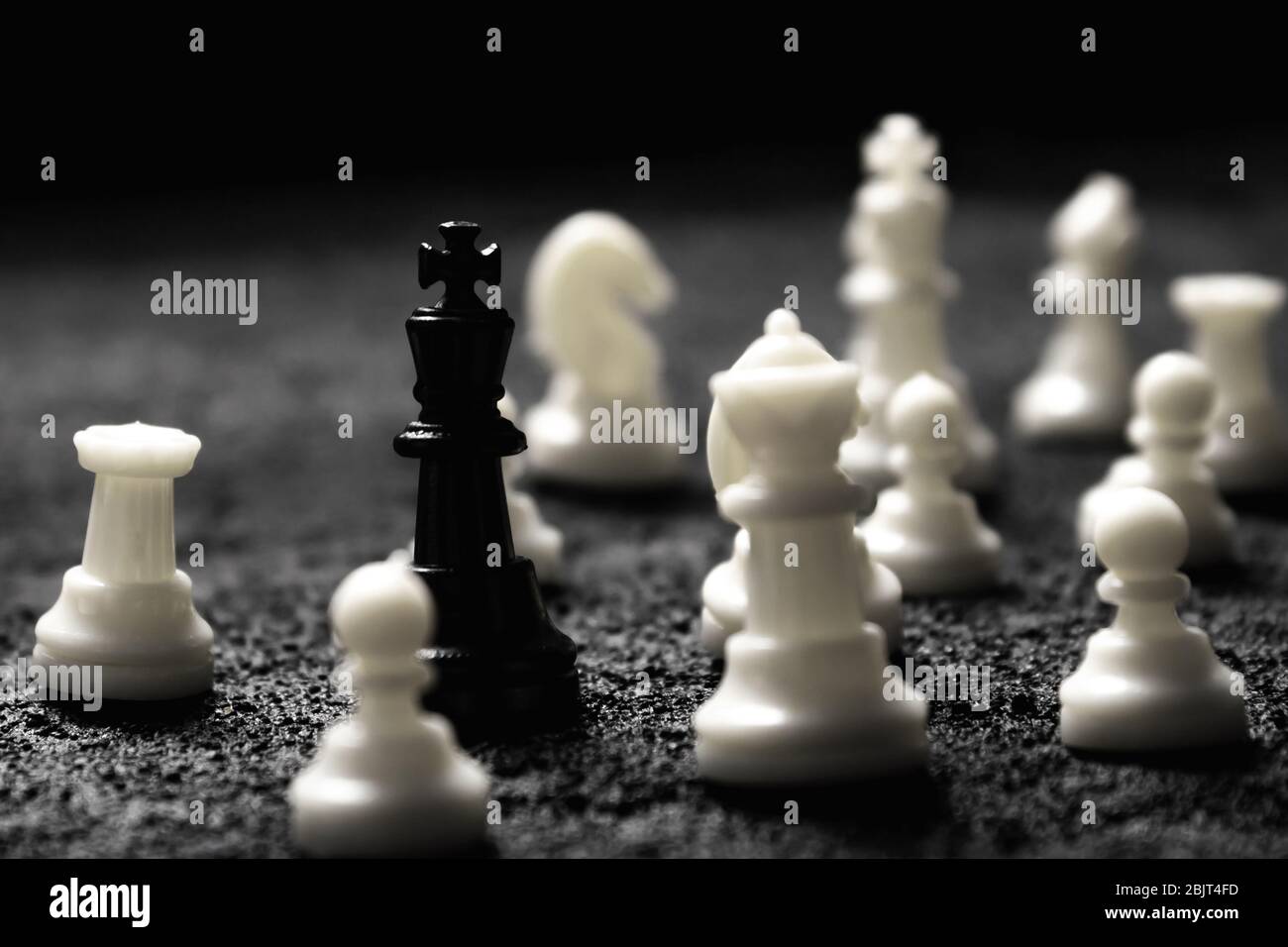 black king surrounded by enemies ambush on black concrete dark ...